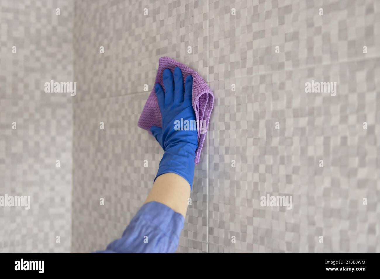 cleaning and washing the bathroom girl washes the tiles Stock Photo - Alamy