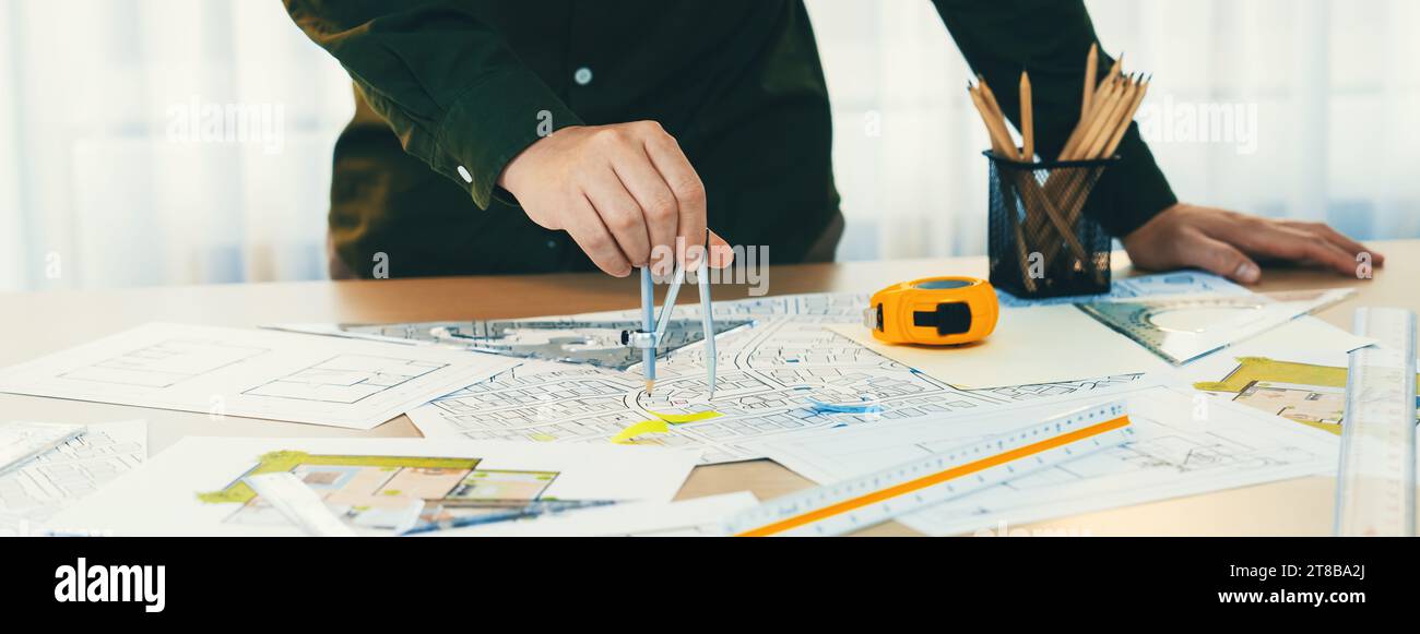 A portrait of architect using divider to measure blueprint. Architect ...