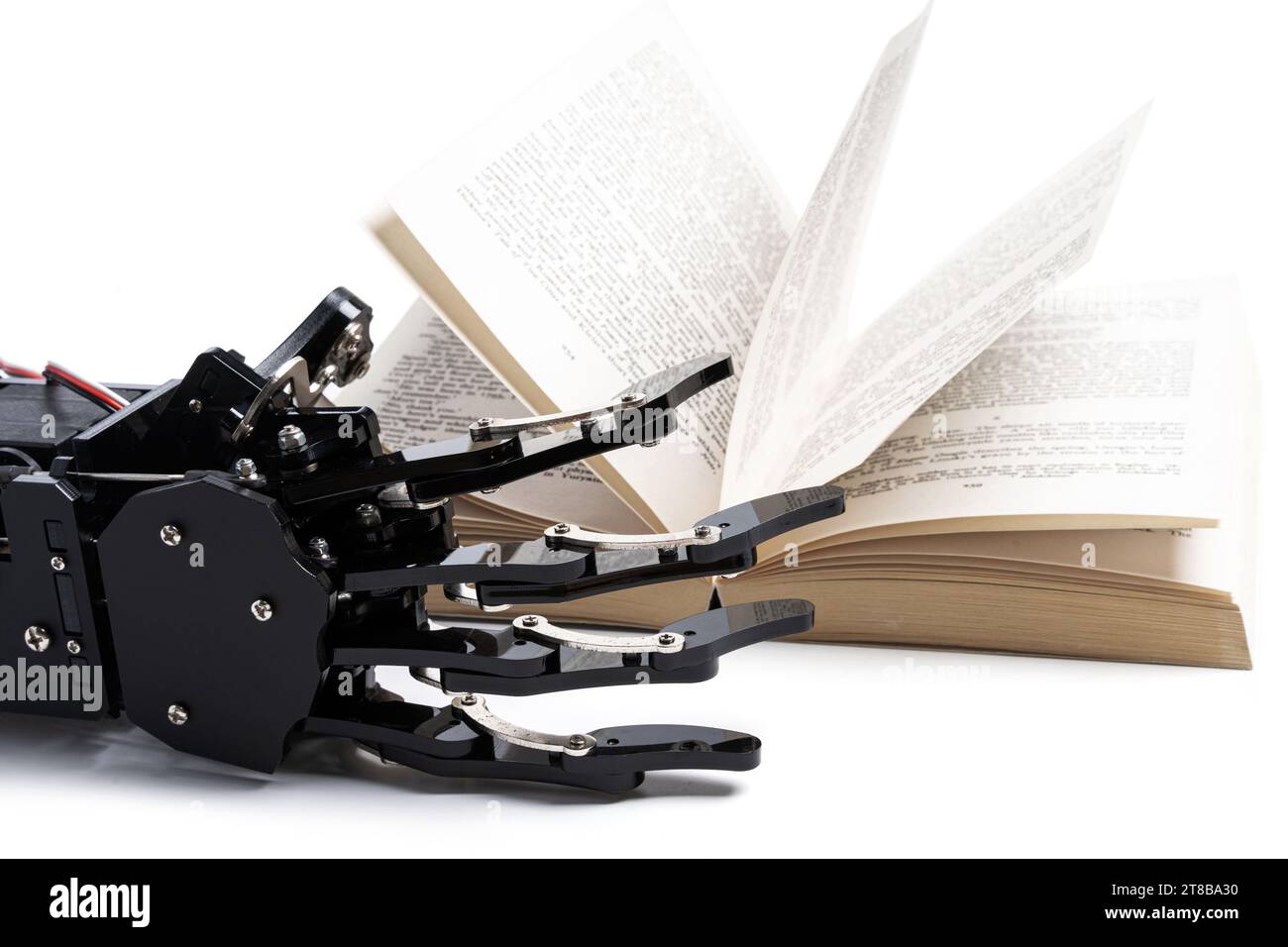 Real robotic hand and opened book. Concept of AI power and machine ...