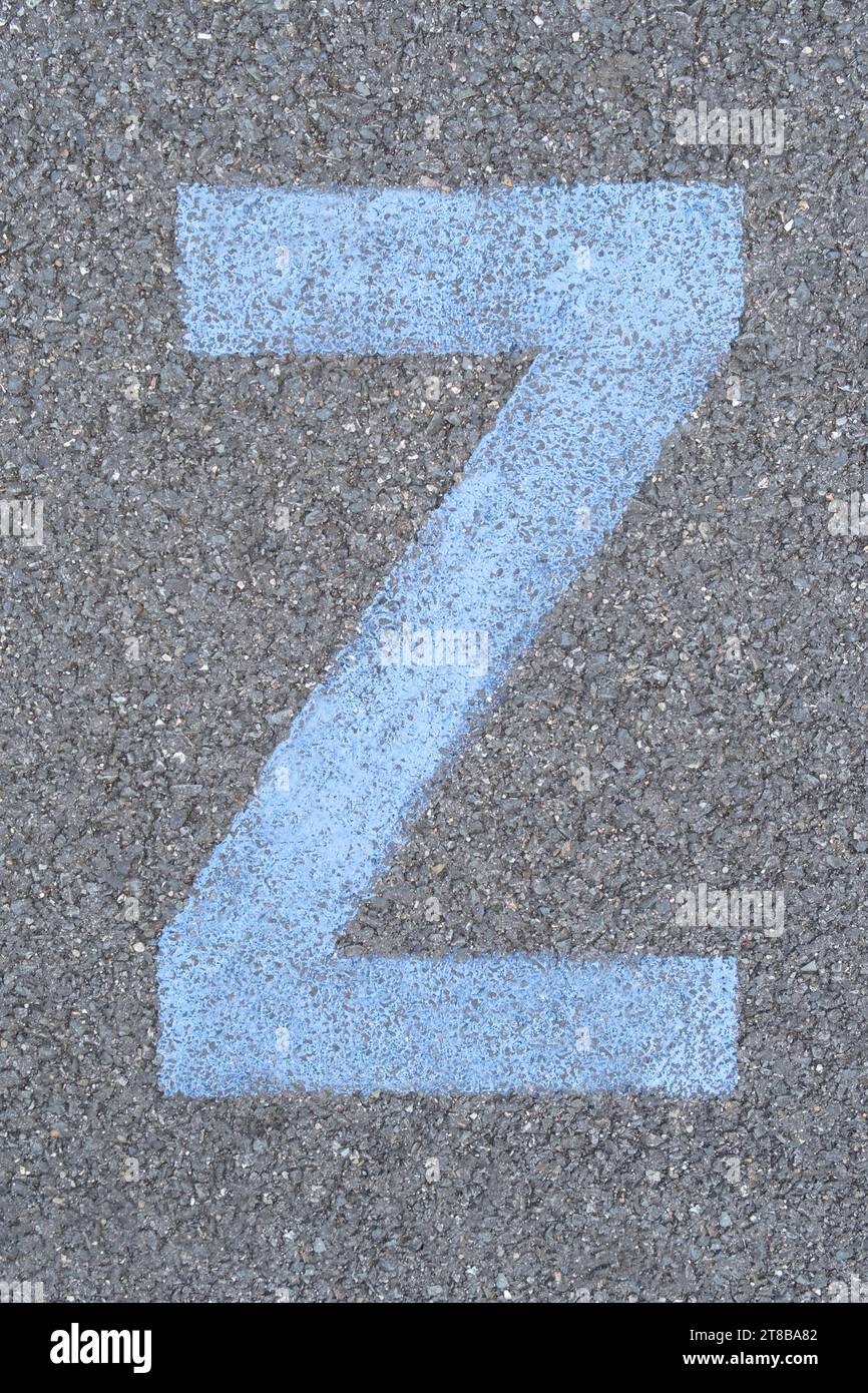 The Letter Z is drawn with color paint on asphalt. a children's ...