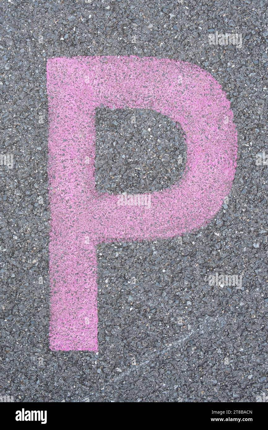The Letter P is drawn with color paint on asphalt. a children's ...