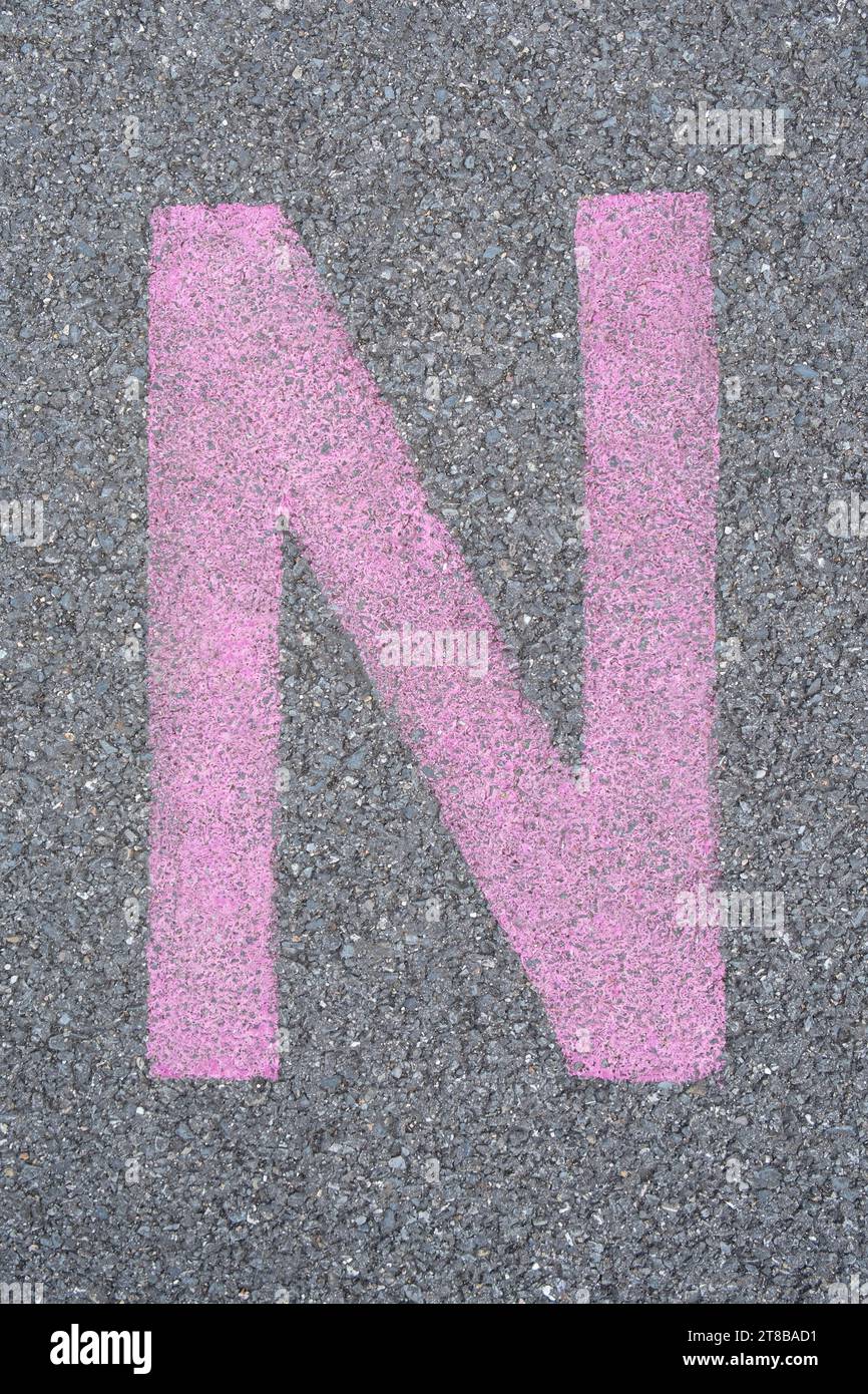 The Letter N is drawn with color paint on asphalt. a children's ...