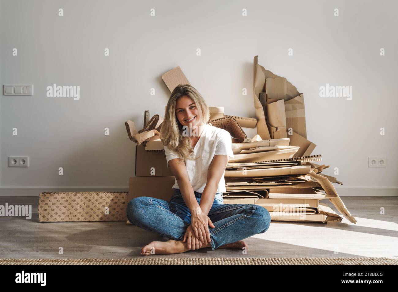 Young woman wand stack of cardboard waste at home. Concepts of Paper ...