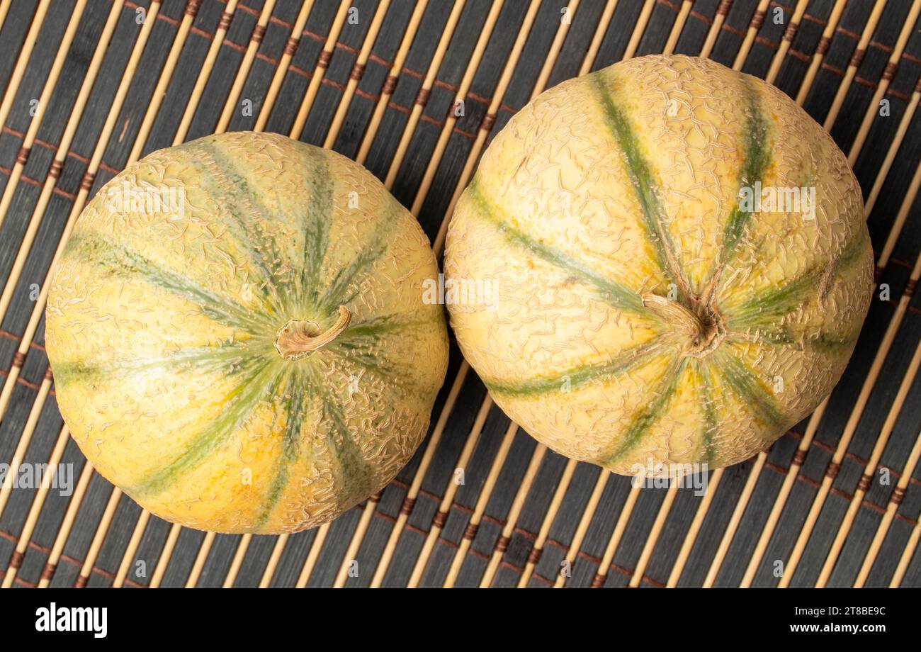 Two fragrant organic melons on a bamboo mat, close-up, top view Stock ...