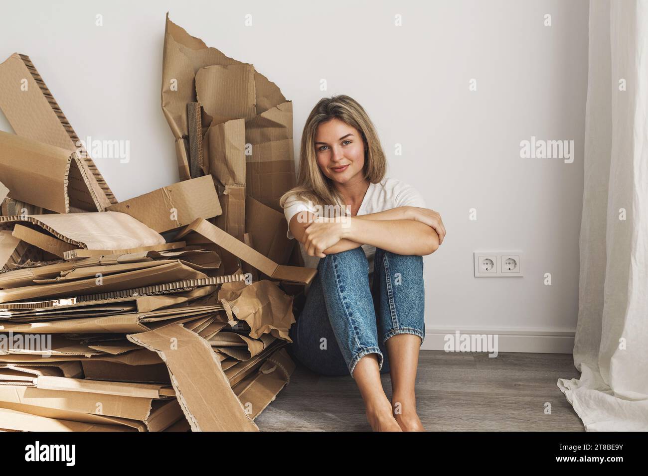 Young woman wand stack of cardboard waste at home. Concepts of Paper ...