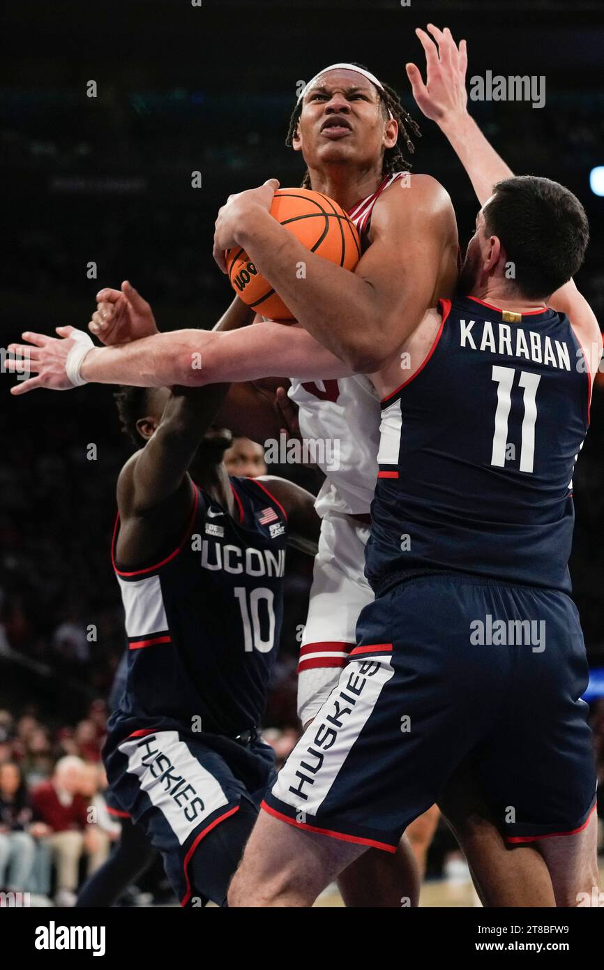 UConn's Alex Karaban (11), right, fouls Indiana's Malik Reneau, top, as ...
