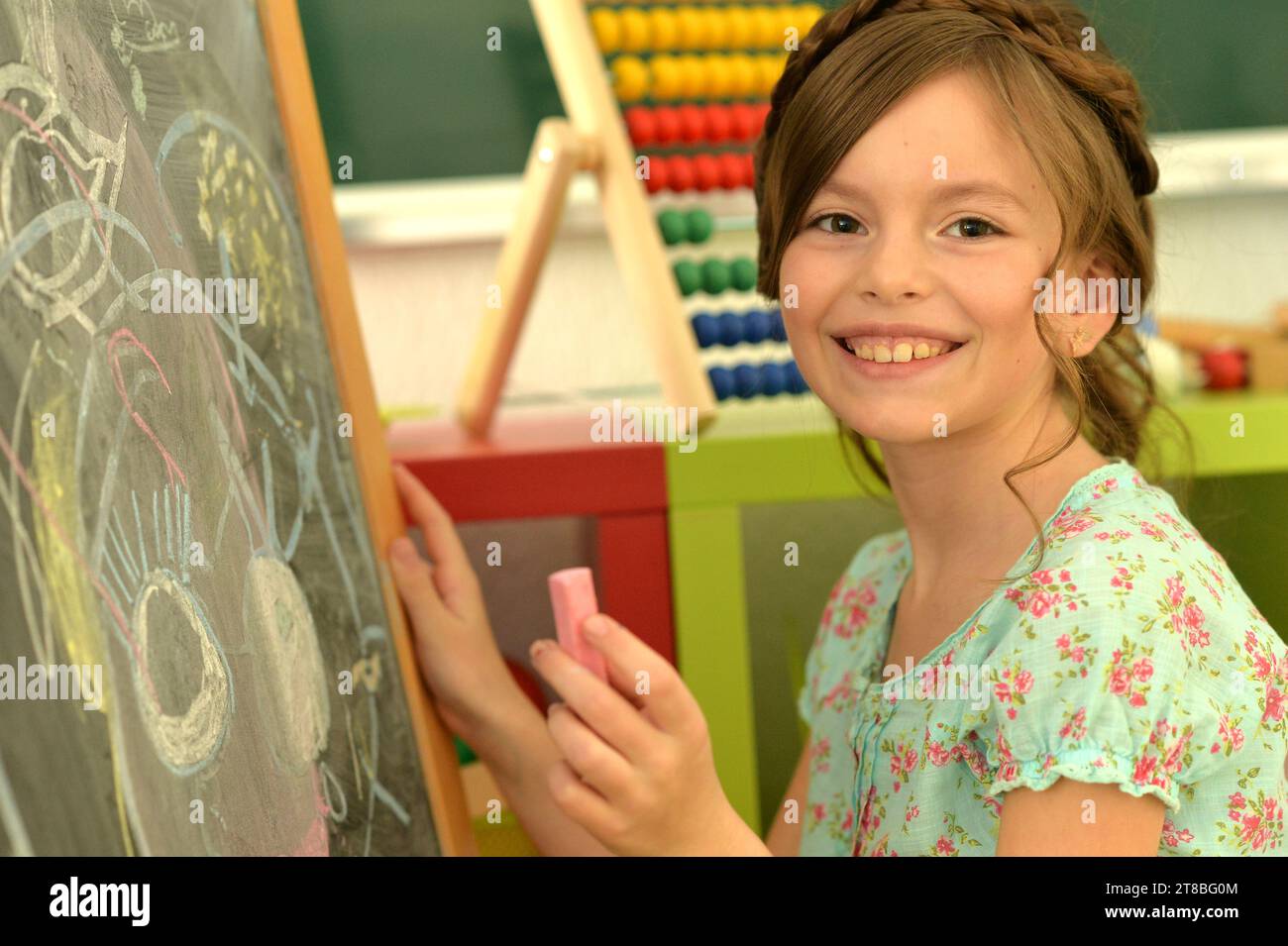 Sweet little girl learning happily in front of her blackboard Stock ...
