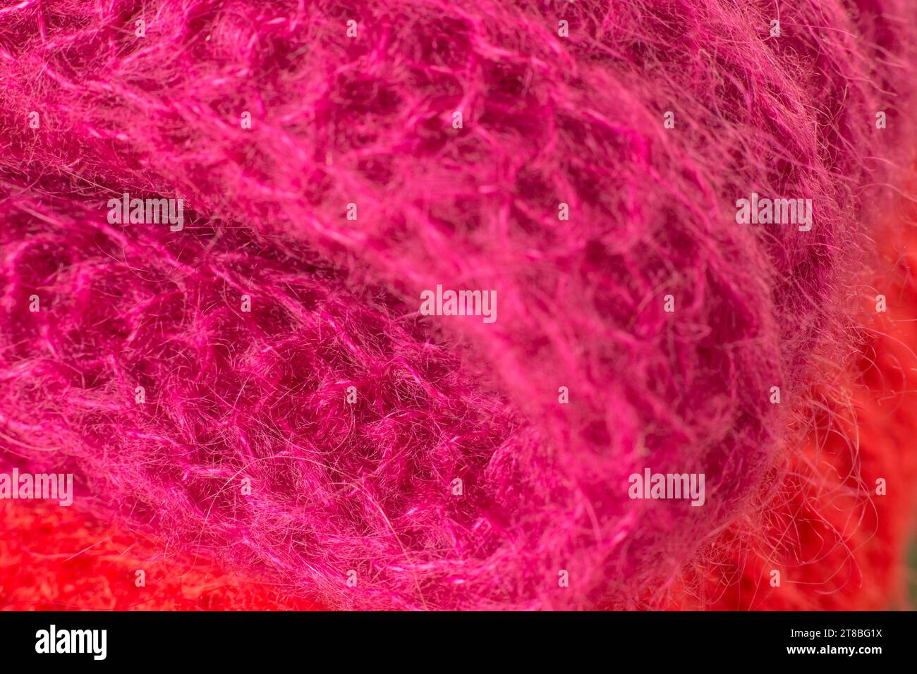 Wool mohair clothes texture closeup. Close-up of red and cherry colored ...