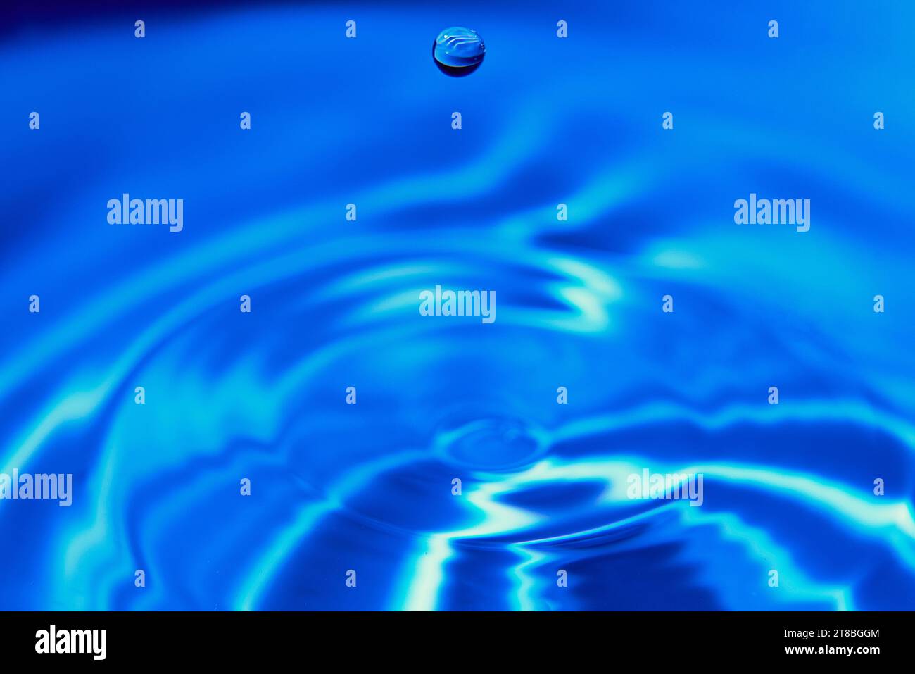 097.One or more drops of water splashing into waves and undefined ...