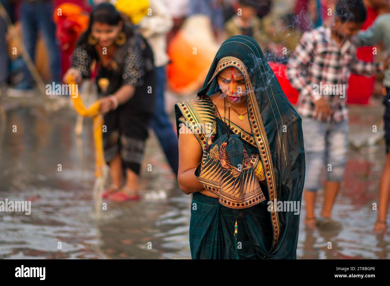 Devotees, carry pooja materials, as they perform rituals on the banks ...
