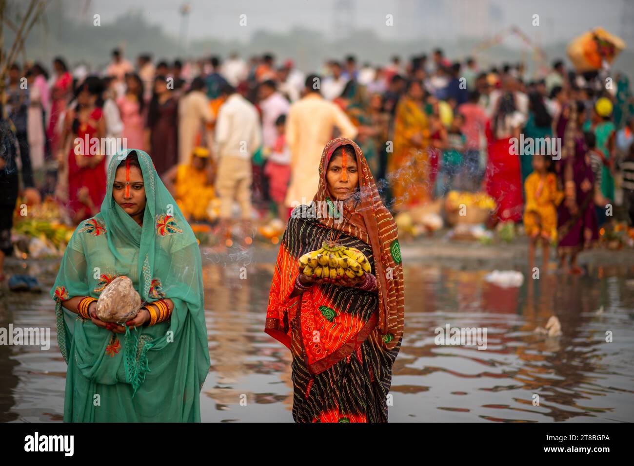Devotees, carry pooja materials, as they perform rituals on the banks ...