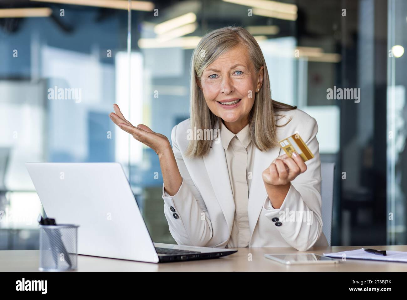 Portrait of a senior gray-haired business woman looking worriedly at ...