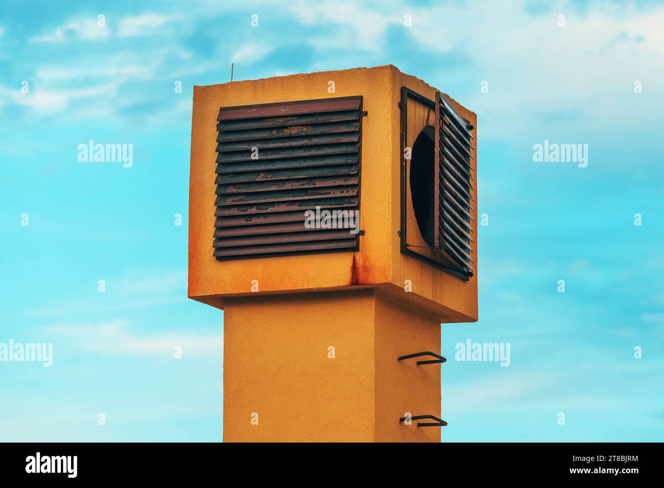 Ventilation chimney outlet with rusty grill against blue sky Stock ...