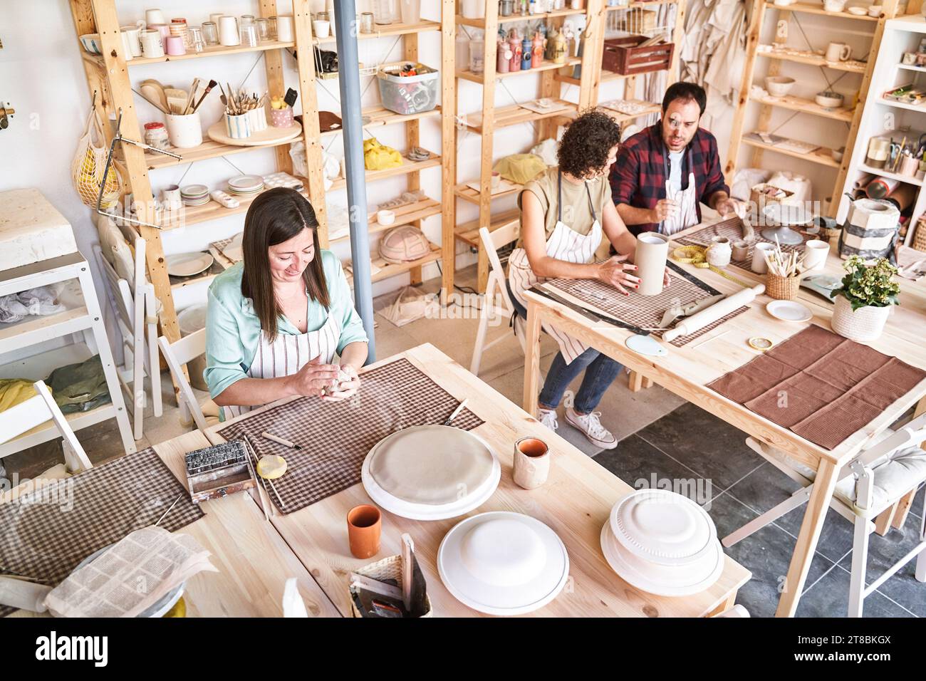 People making handicrafts in a pottery workshop. Hobby, pottery and handicraft concept Stock ...