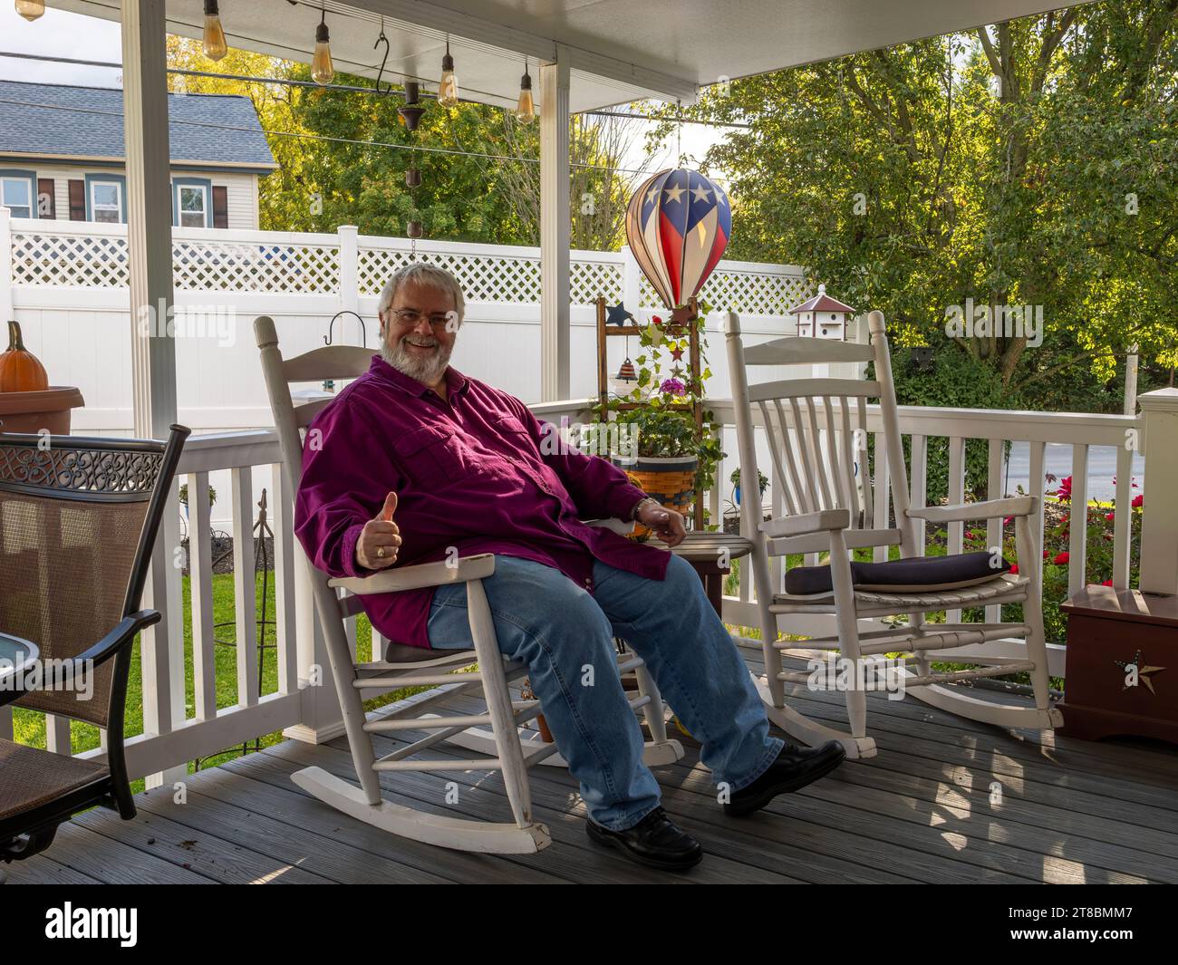 A Senior Aged Male Resting in a Rocking Chair, on a Deck, Enjoying His ...