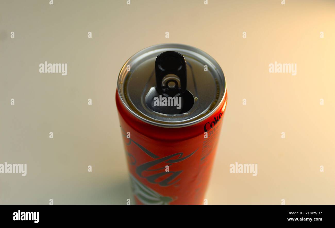 A close up photo of a red and black Coca Cola Zero can on a white desk ...