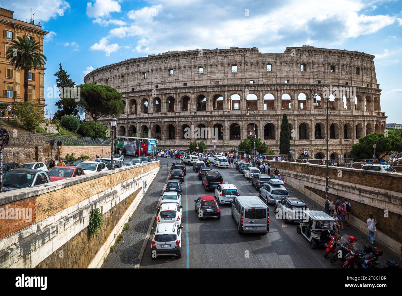 The coliseum in Rome, Italy with street and cars in front Stock Photo ...