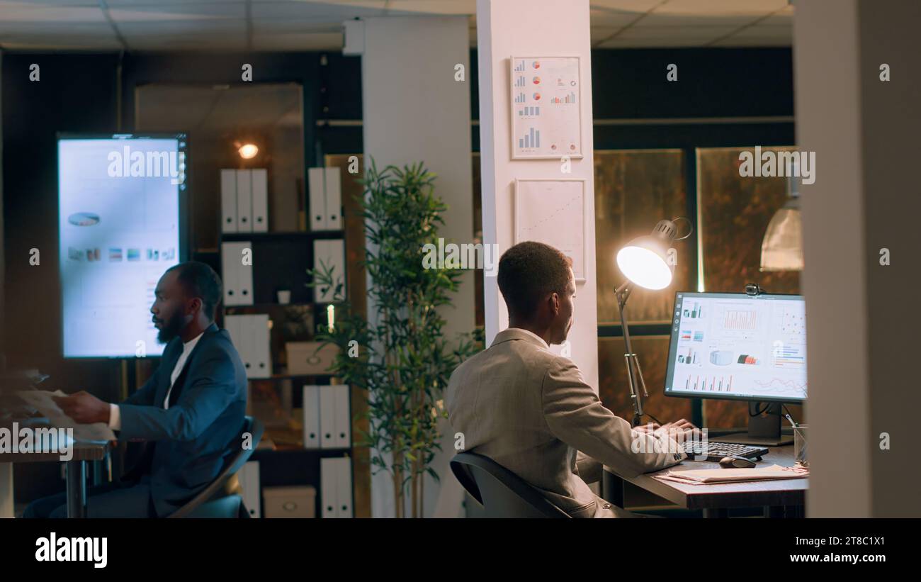 Supervisor teaching newcomer how to properly solve project tasks during ...