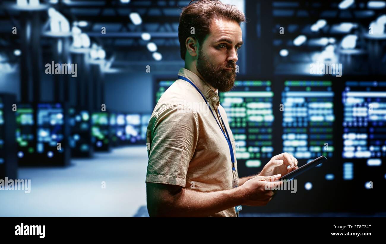 Engineer in data center using renewable solar and wind energy sources ...