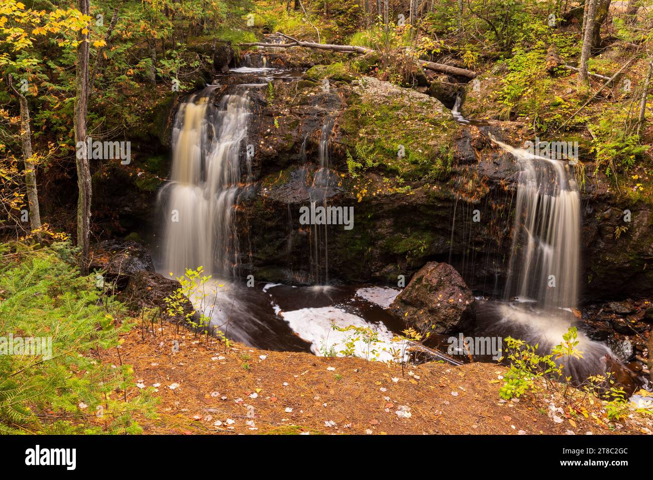 A split waterfall on a creek in the woods during autumn Stock Photo - Alamy