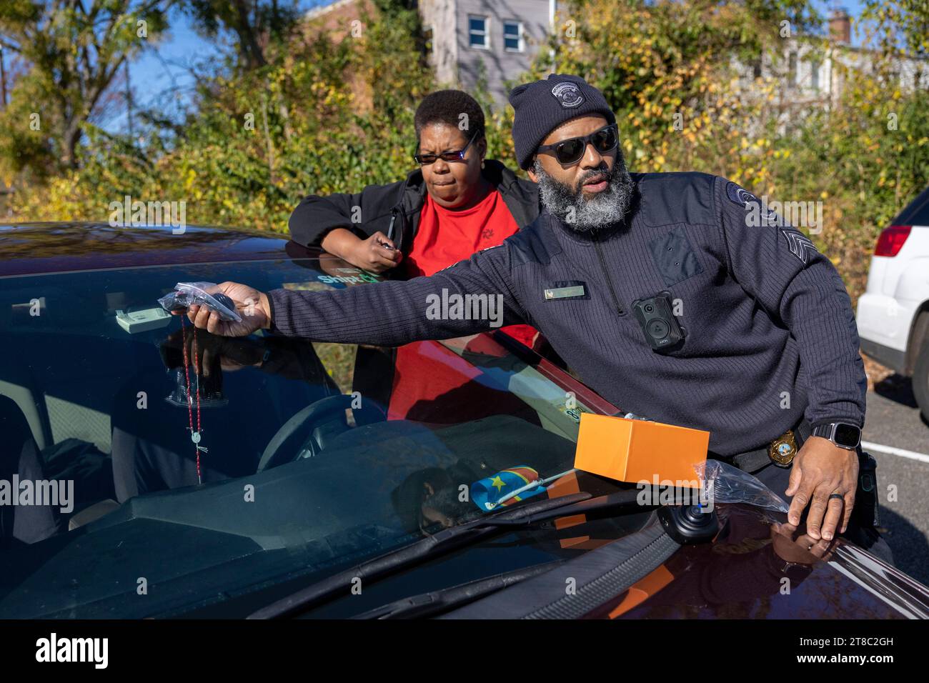 Sgt. Jason Godfrey explains to Grace Djemba, a delivery driver, the ...
