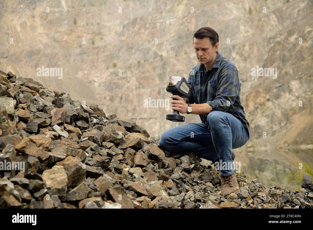 Geologist man scientist testing with XRF analyzer for gold and other ...