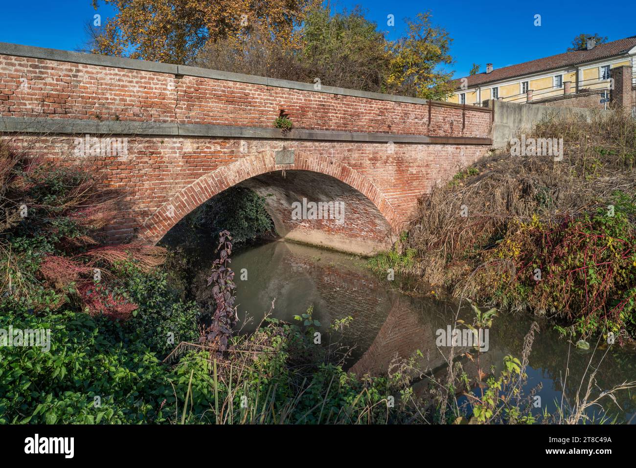 Ancient arched brick bridge, built in 1839, over canal in the Po Valley ...