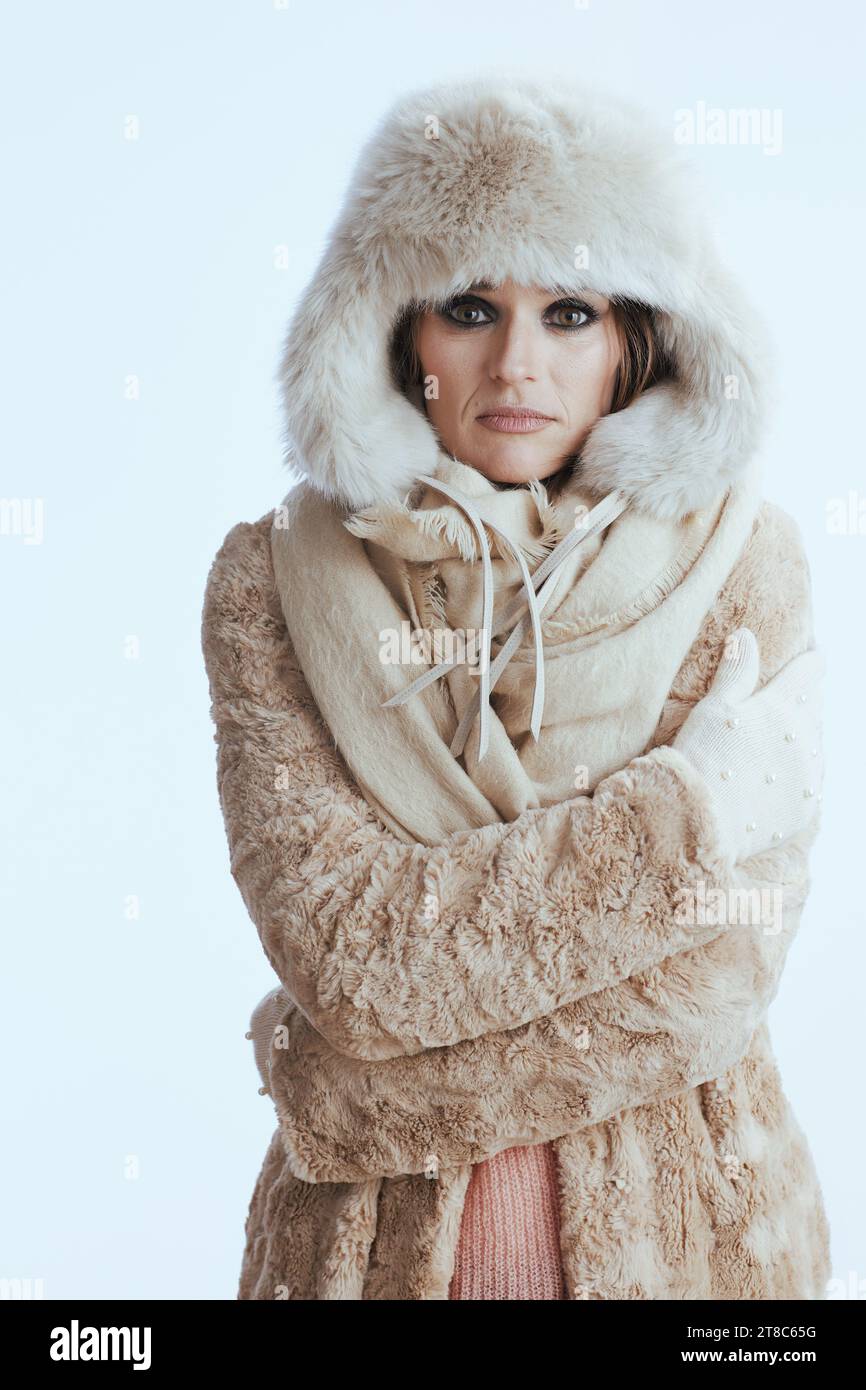 sad modern middle age woman in winter coat and fur hat isolated on ...