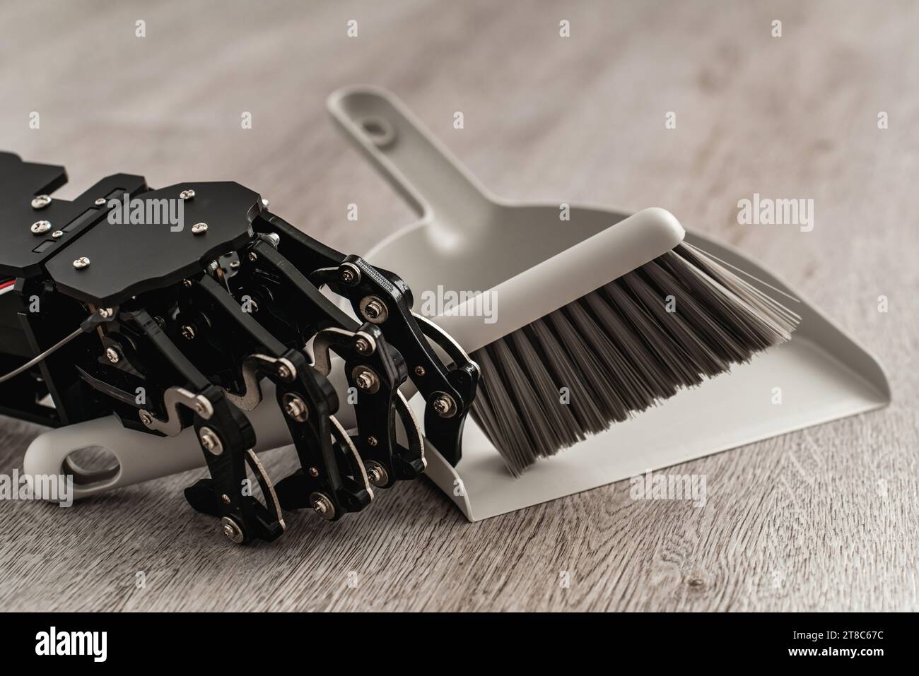 Robotic hand skillfully using a dustpan and brush to sweep the floor ...