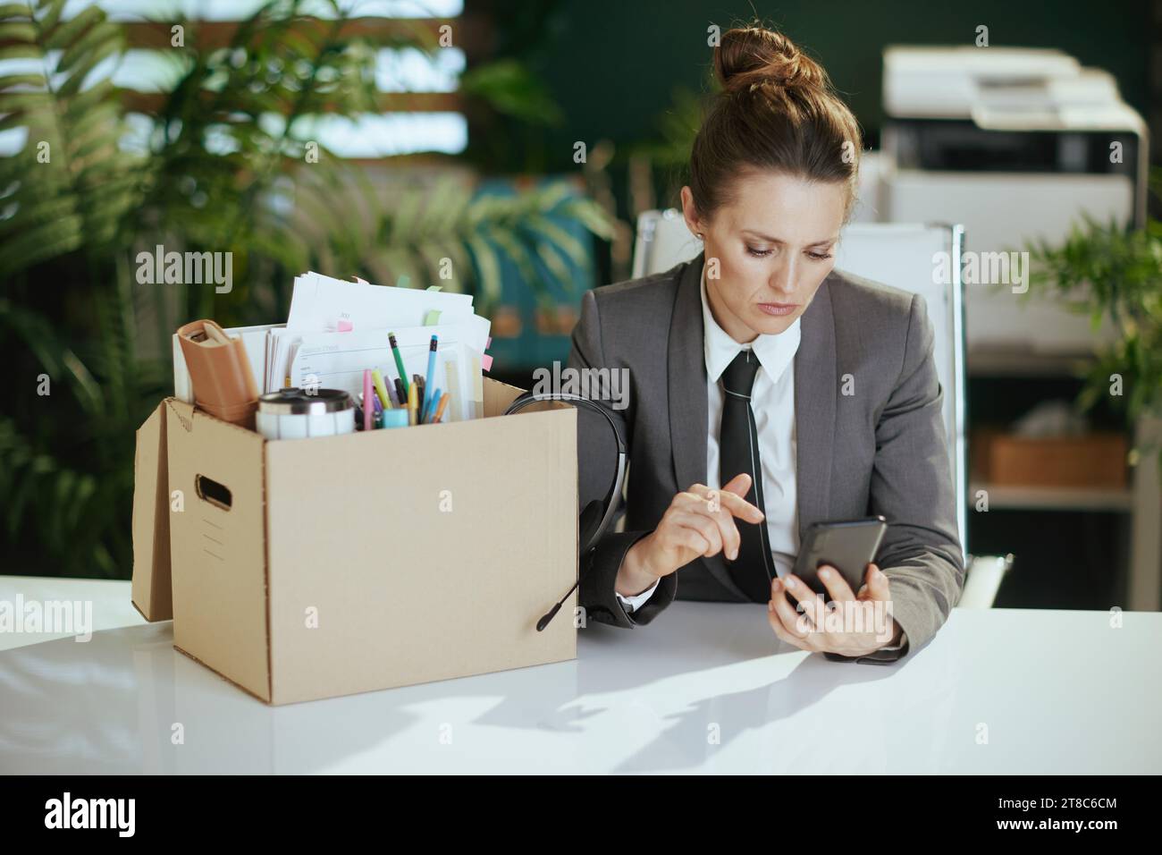 New job. concerned modern 40 years old woman employee in modern green ...