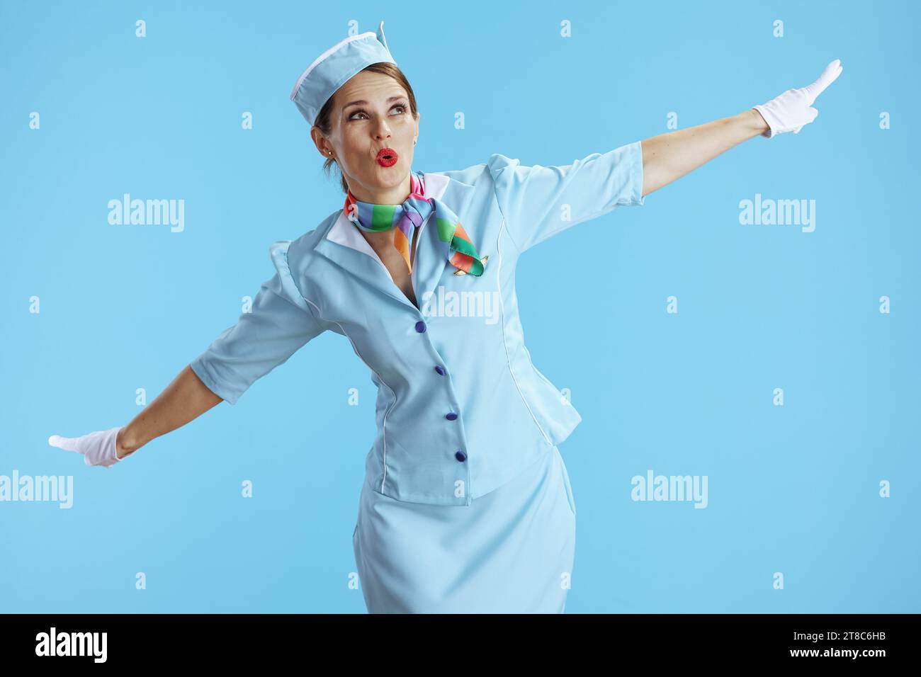 happy stylish female stewardess on blue background in blue uniform with ...