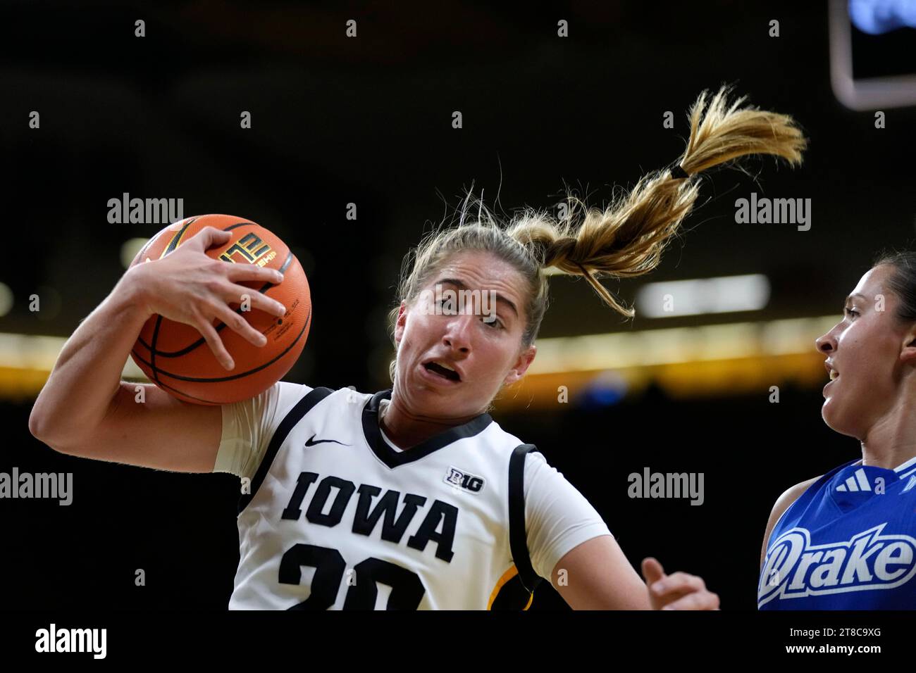 Iowa guard Kate Martin (20) grabs a rebound in front of Drake forward ...