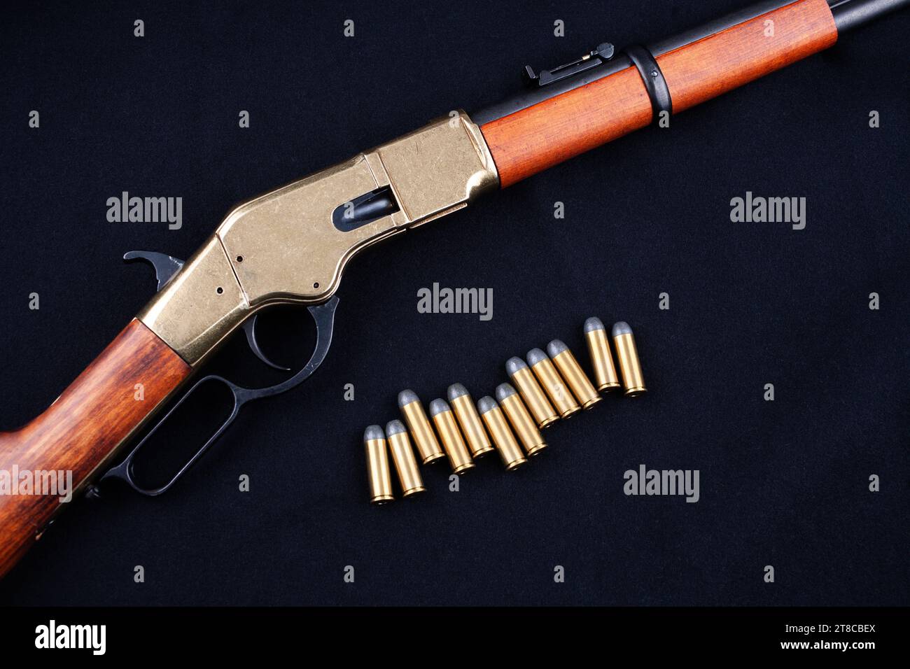 Old west lever action rifle with ammunition on black canvas Stock Photo ...