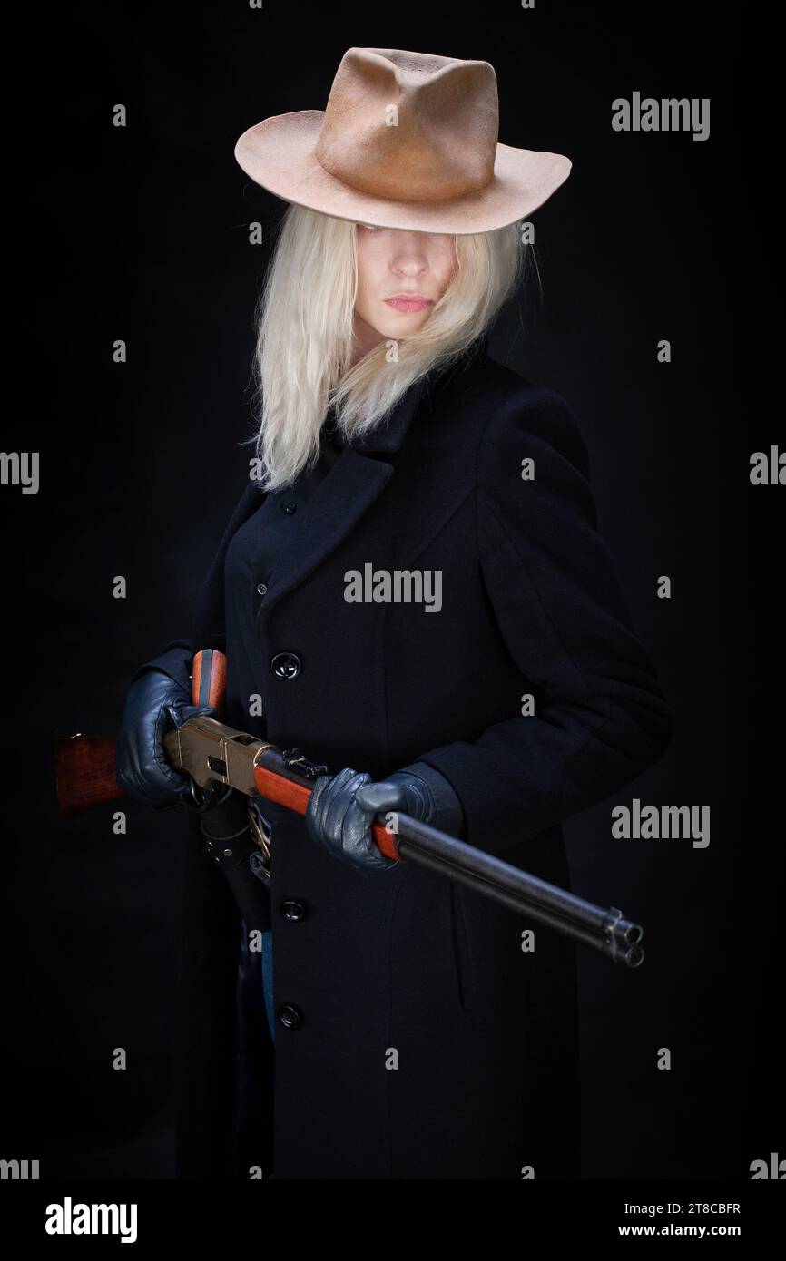 Old west girl in white hat with rifle on black background Stock Photo - Alamy