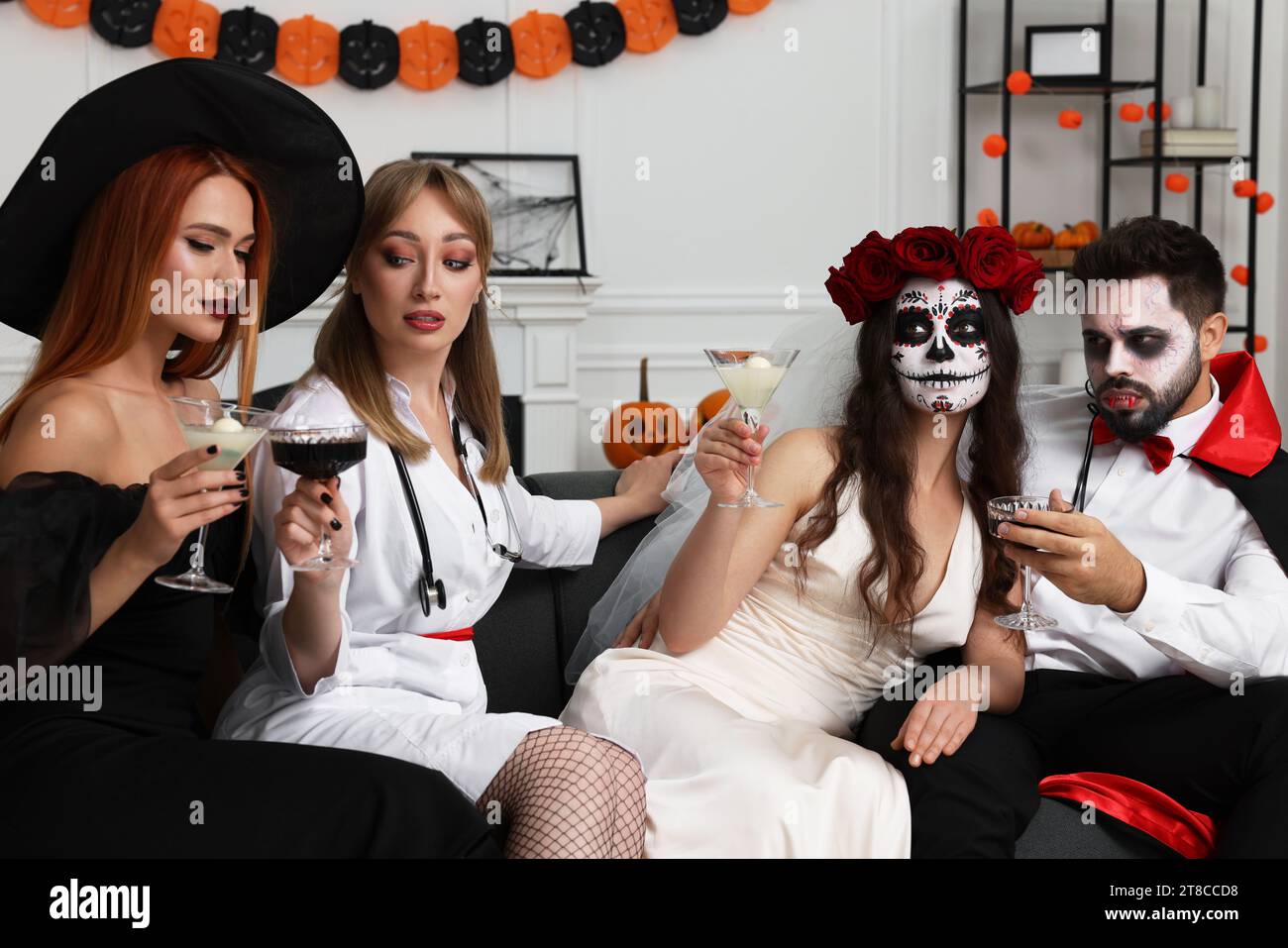 Group of people in scary costumes with cocktails celebrating Halloween ...