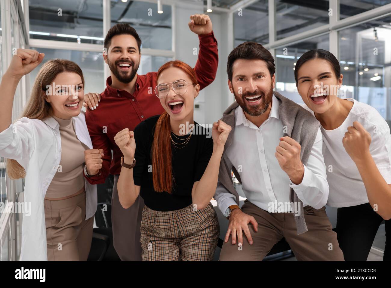 Team of employees celebrating success in office Stock Photo - Alamy