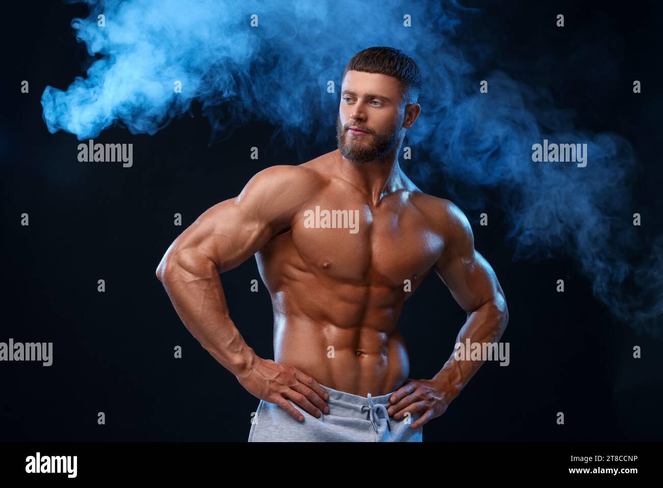 Young bodybuilder with muscular body in smoke on color background Stock ...