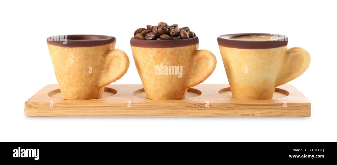 Edible biscuit cups with espresso, coffee beans and empty one on white ...