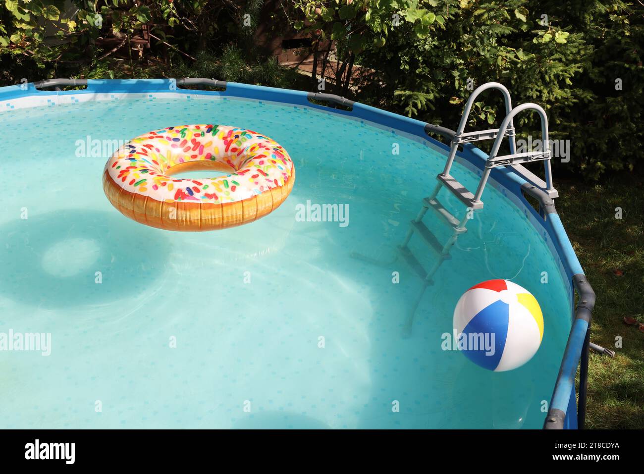 Inflatable ring and ball floating on water in above ground swimming ...