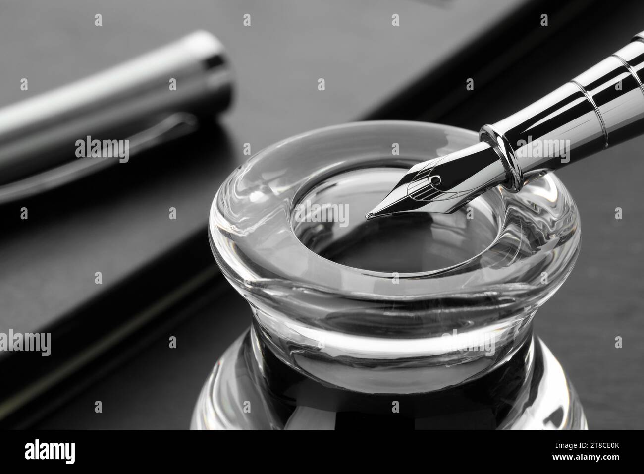 Inkwell with fountain pen on grey table, closeup Stock Photo - Alamy