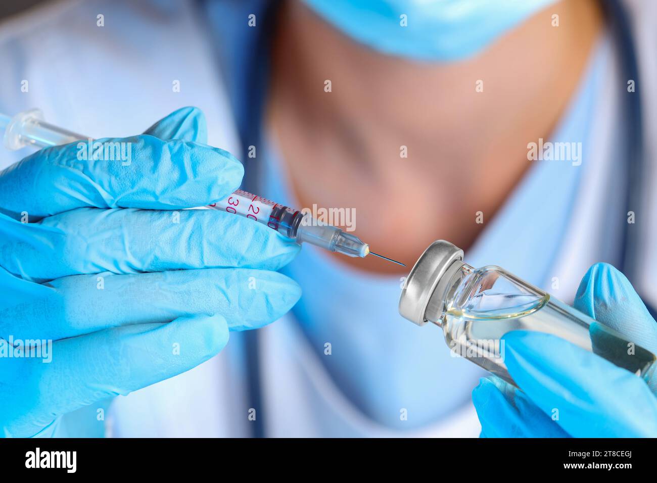 Doctor inserting syringe into glass vial with medication, closeup Stock ...