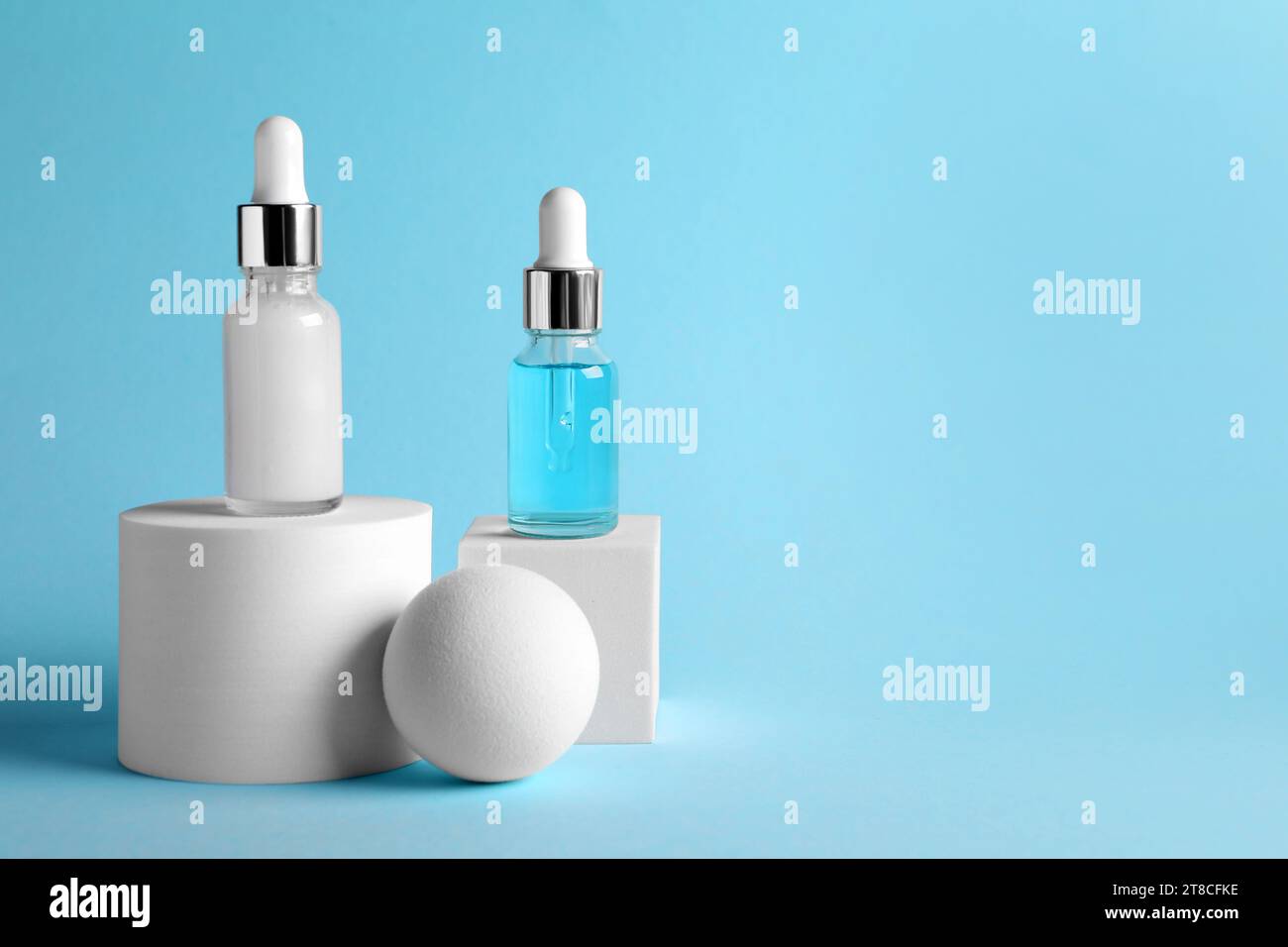 Stylish presentation of cosmetic serum on light blue background, space ...