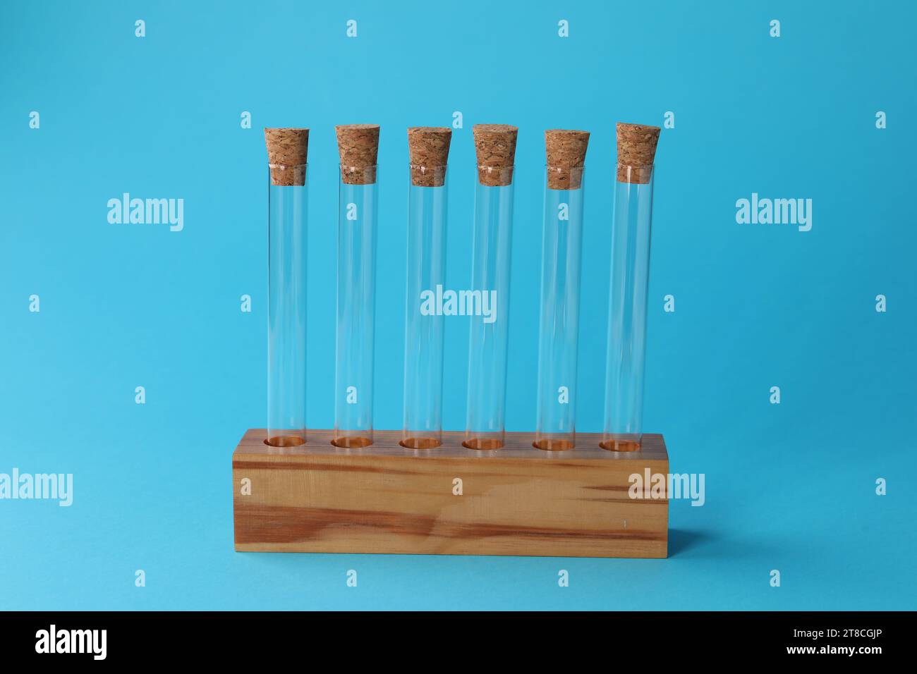 Test tubes in wooden stand on light blue background. Laboratory ...