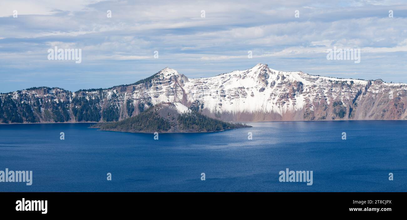 Panorama of Crater Lake blue water with Wizard Island and snow on rim ...