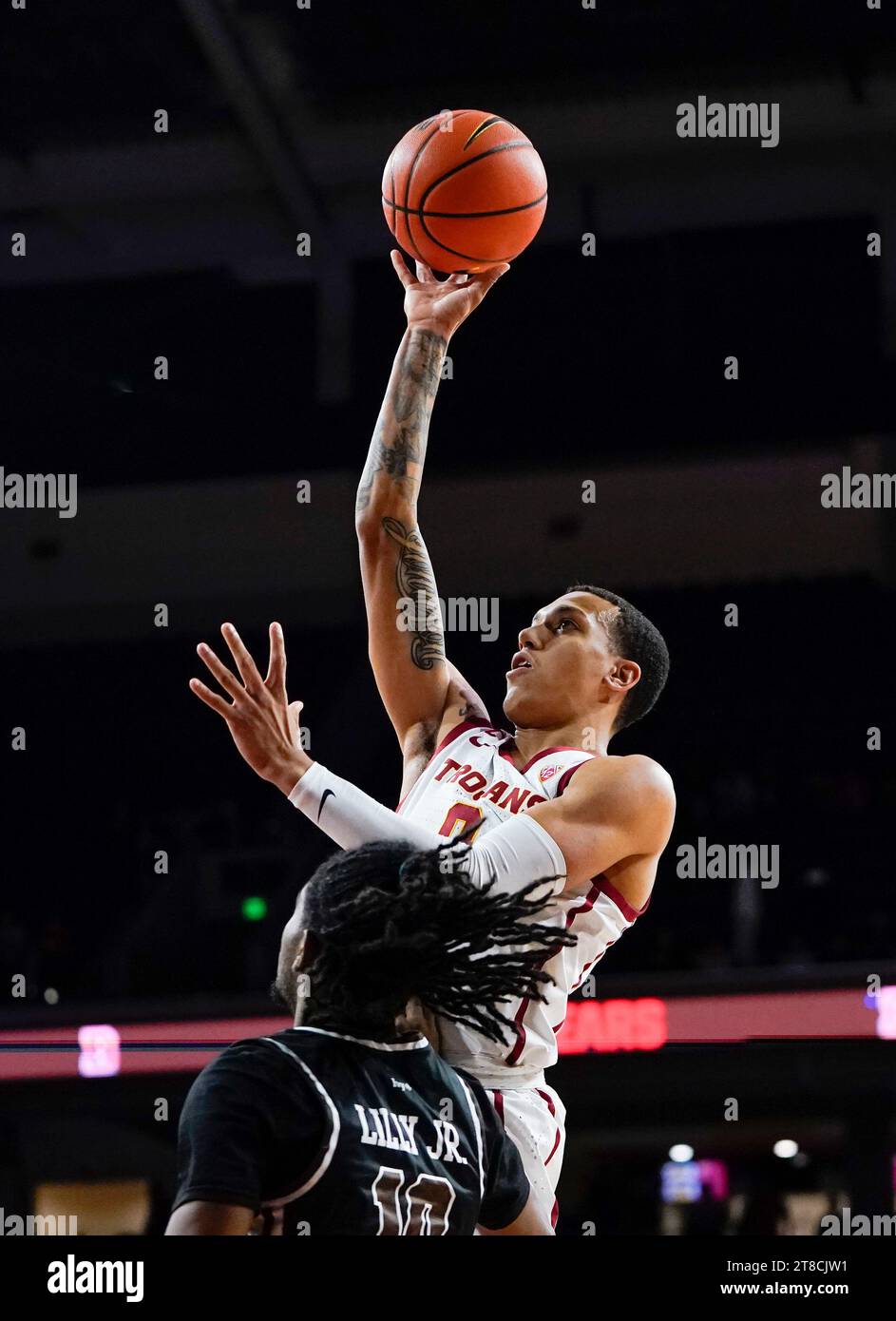Southern California guard Kobe Johnson, top, shoots against Brown guard ...