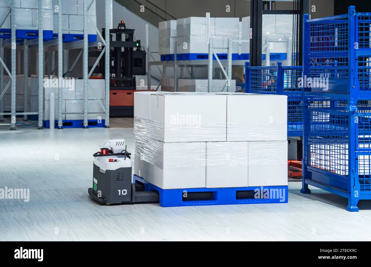 warehouse robot car carries cardboard box assembly in factory Stock Photo - Alamy