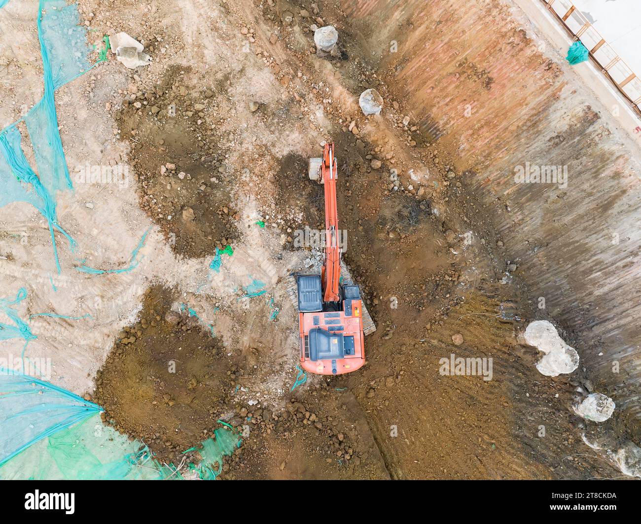 Excavator on earthmoving at construction site, aerial view Stock Photo ...