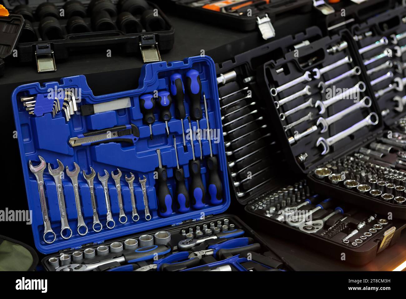 Tool kits in plastic boxes on the showcase of tool store. Selective ...