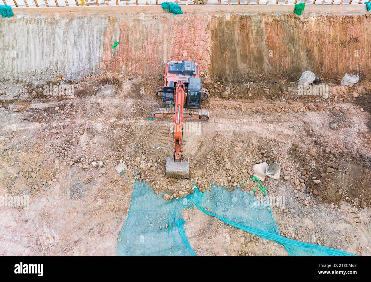 Large tracked excavator with hydraulic hammer breaks asphalt at a ...