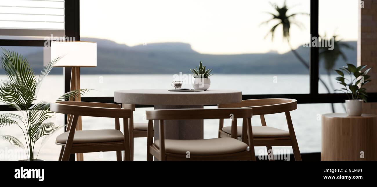A modern room with round table and wooden armchairs by the large window ...